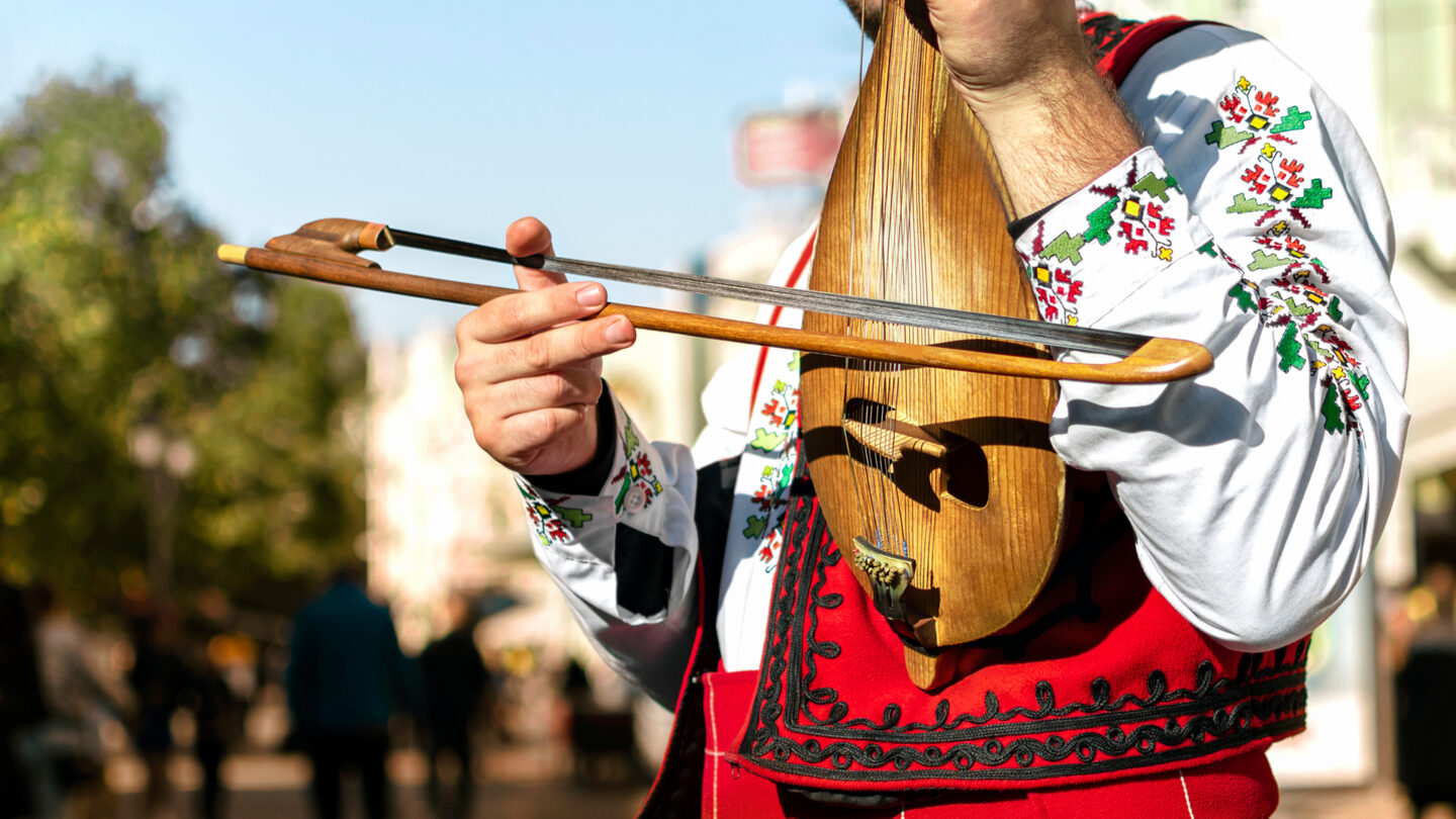 Bulgarian folk musician - violinist in traditional national costume ...